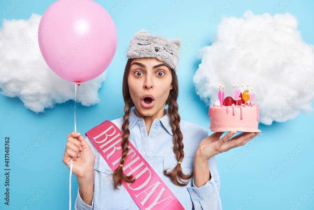 Shocked beautiful woman celebrates birthday poses with cake and ...
