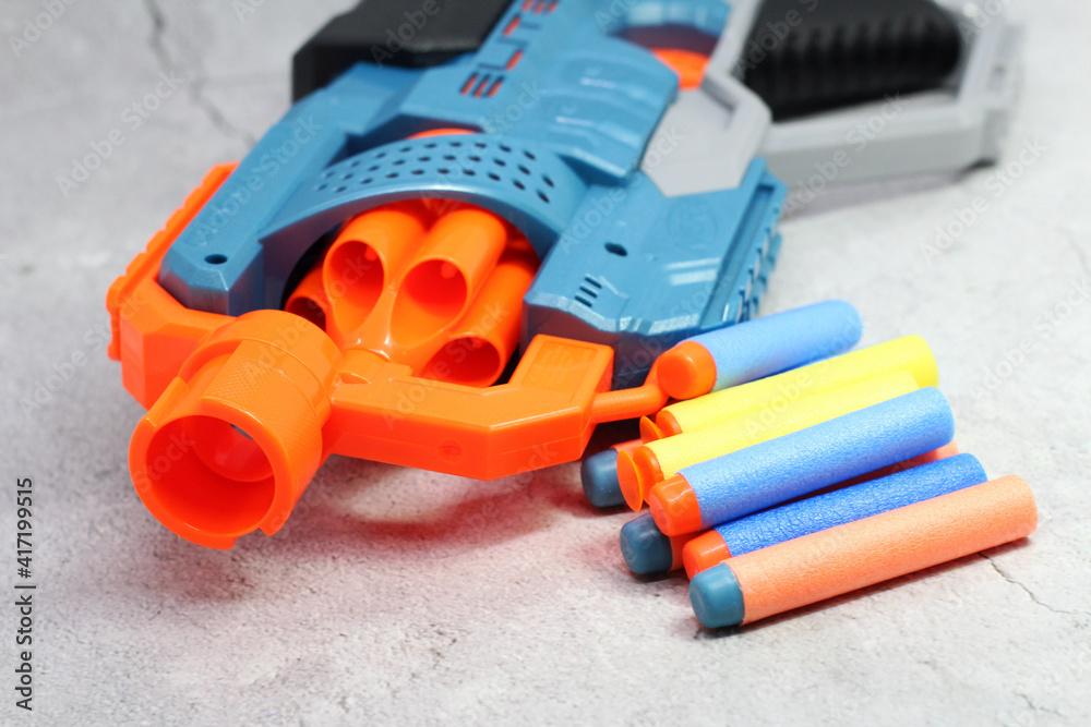Foam bullet and gun toy, foam-based weaponry Stock Photo | Adobe Stock