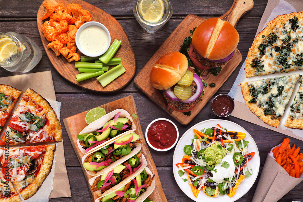 Healthy plant based fast food table scene. Overhead view on a wood ...