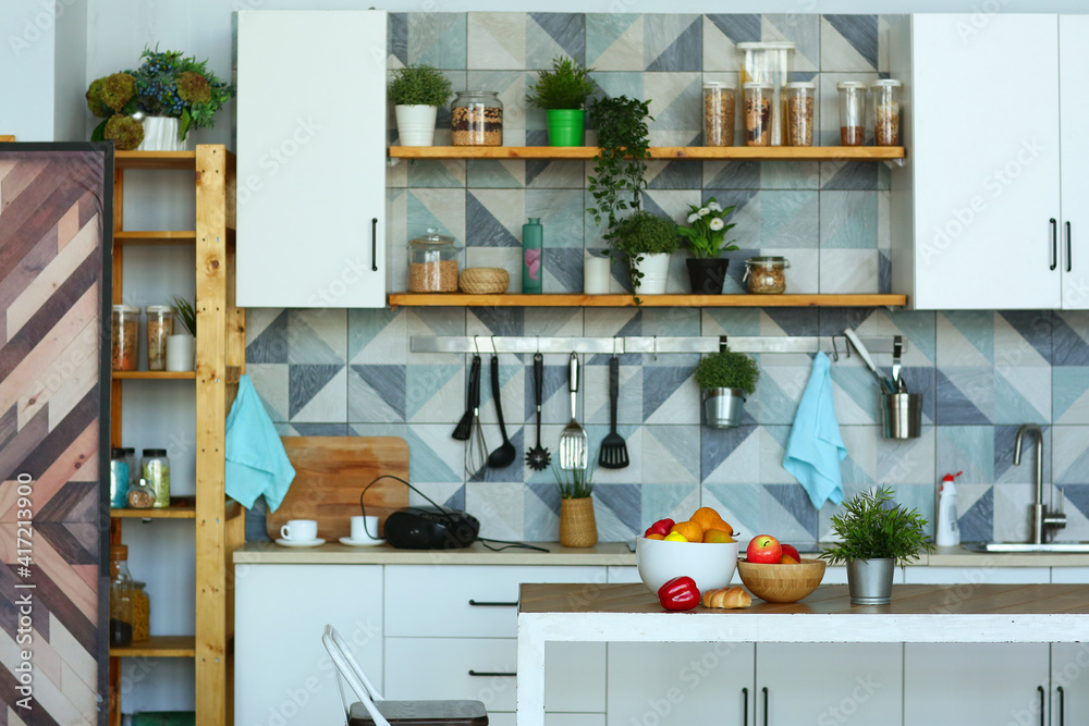 kitchen close up fragment with pot plants, utensils, peas and beans in ...
