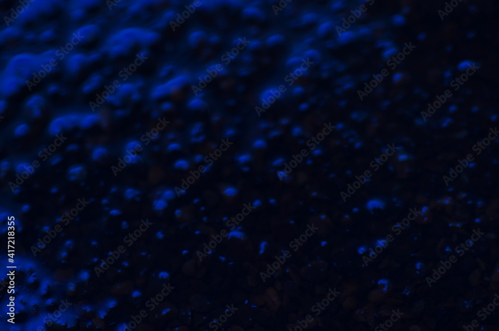 Abstract blue mysterious background. Rough texture in dark light. Oily ...