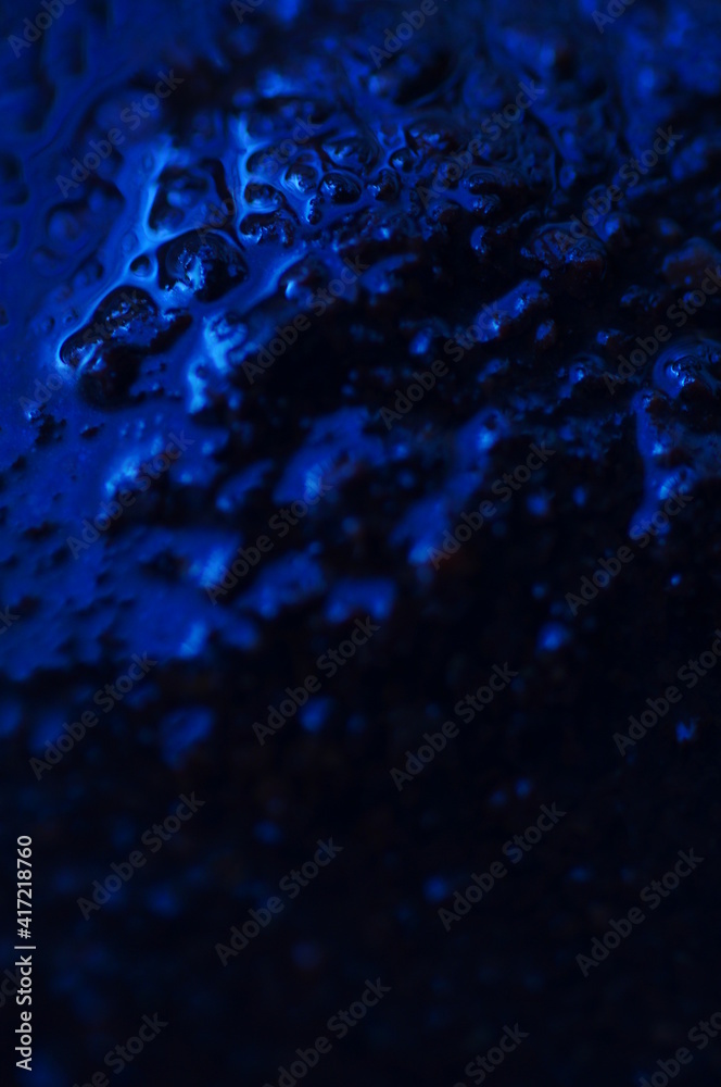Abstract blue mysterious background. Rough texture in dark light. Oily ...