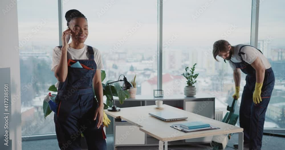 lazy african young talkative woman dialing mobile phone while her tired ...