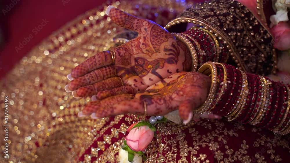 Beautiful Indian bride in wedding dress showing henna tattoo art made ...