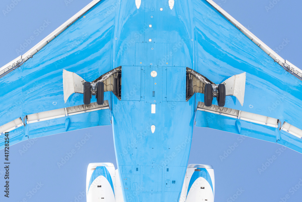 View from below under the flying airplane before landing, in detail ...