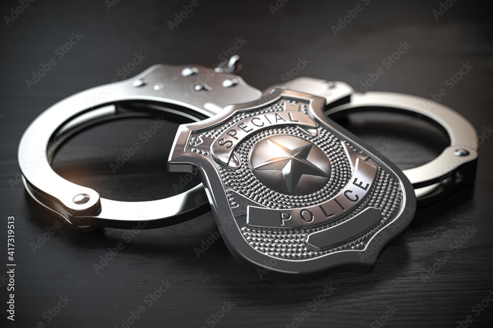 Special police badge and handcuffs ion wooden table. Law enforcement ...