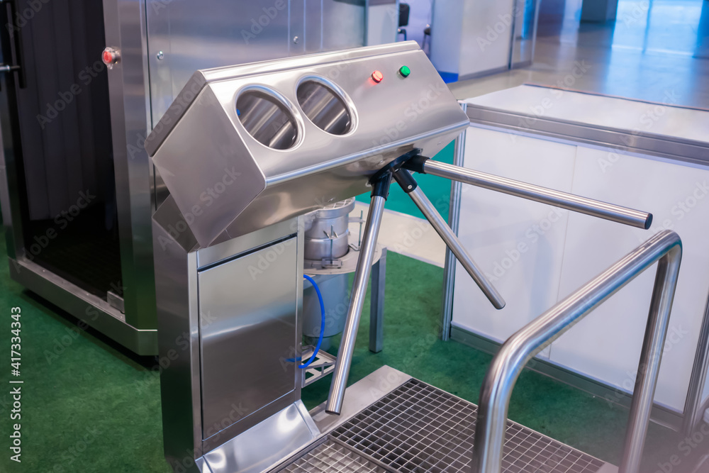 Hand hygiene station with turnstile gate and sanitizer before entering ...