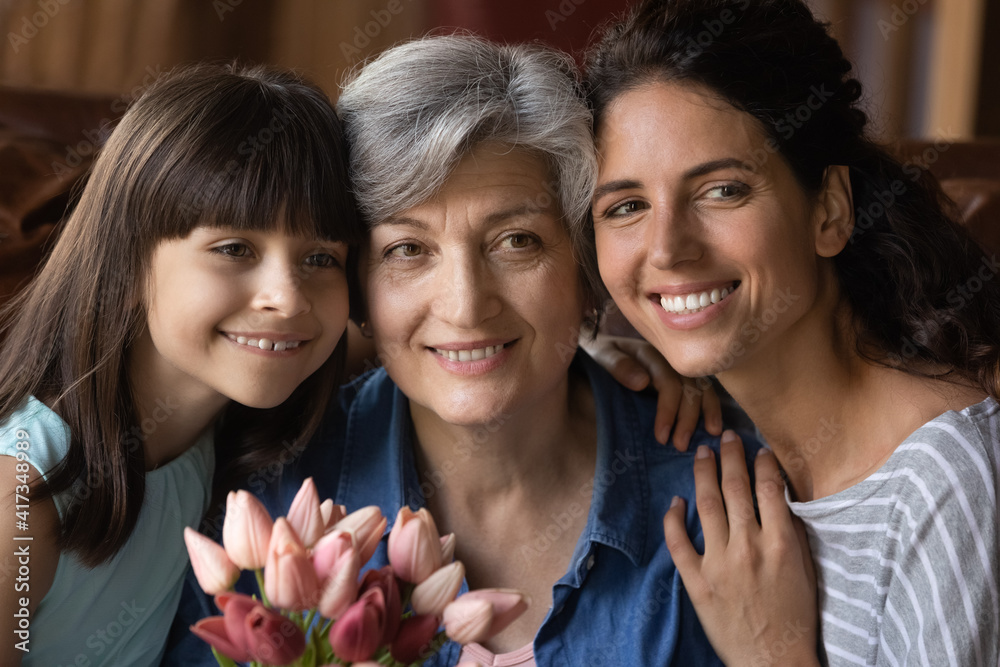 Close up family portrait of happy three generations of Hispanic women ...