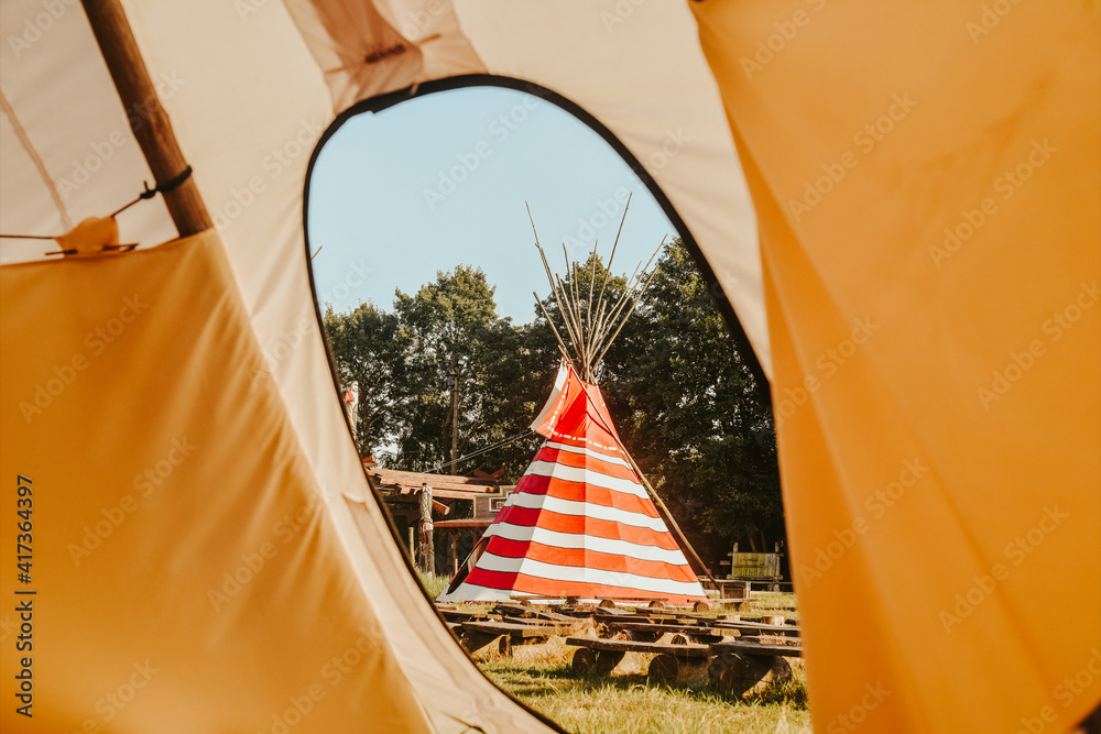 Tipi house in the forest against the background of trees, camping ...