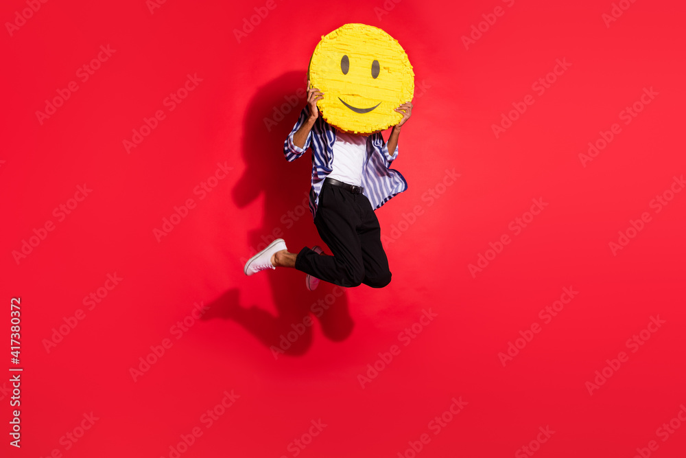 Full size photo of young black man jump up cover face figure smile ...