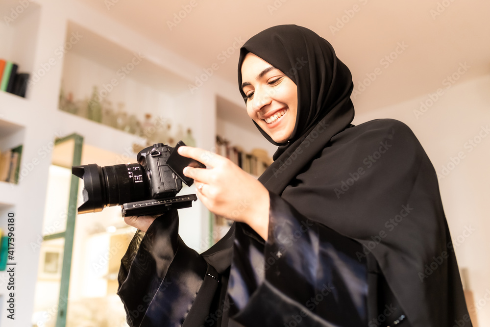 Young muslim woman with camera, smiling Stock Photo | Adobe Stock