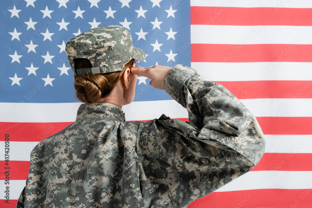 Back view of soldier saluting near american flag at background Stock ...