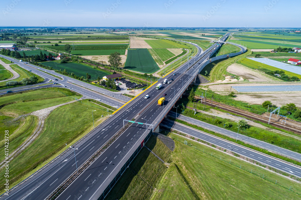 Motorway viaduct over the local road in rural areas. In the background ...