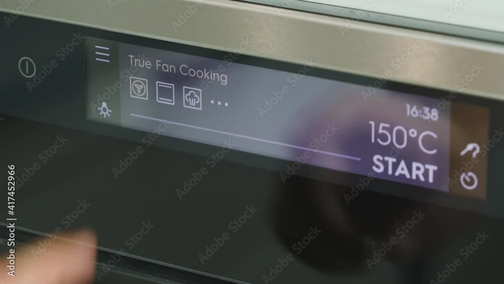 Man cook sets temperature for baking in oven. Cooking program. Oven ...