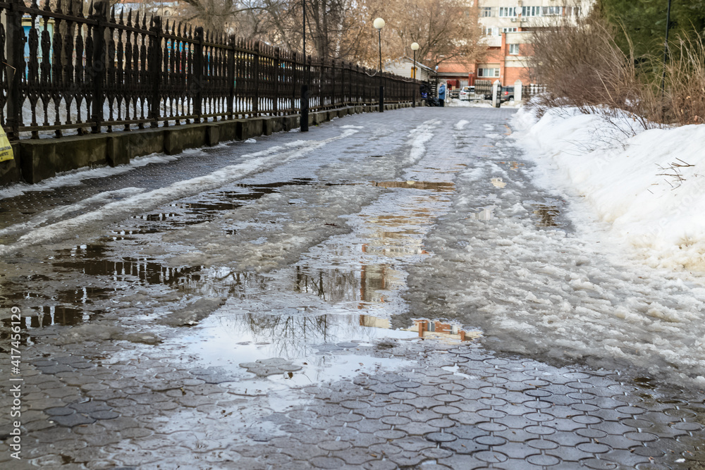 Slush.Asphalt road covered with melting dirty snow and mud on an early ...