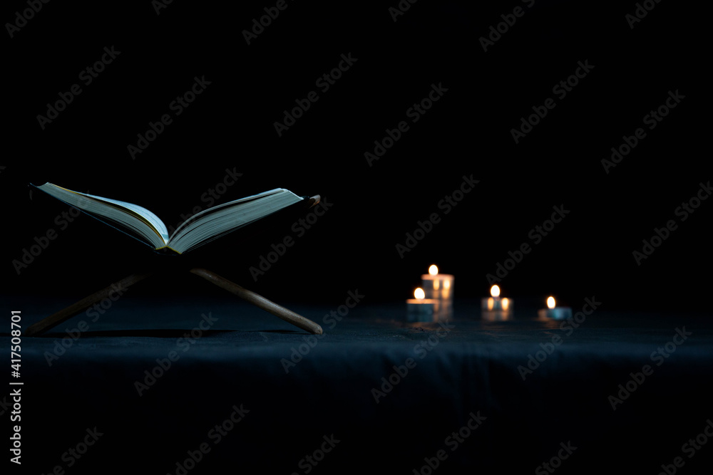 Quran in the mosque - open for prayers The black background of the ...