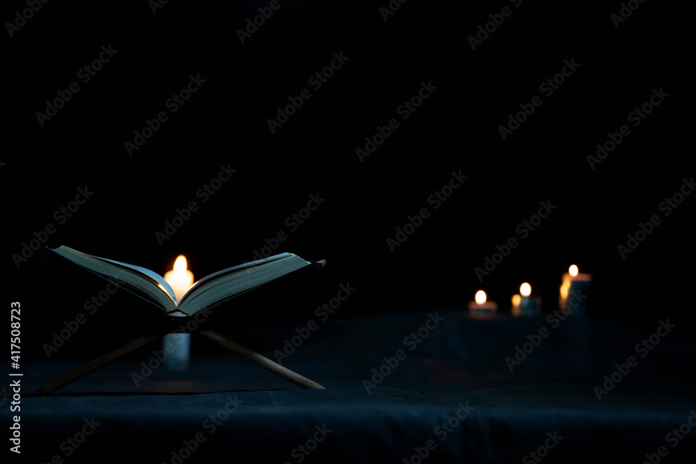 Quran in the mosque - open for prayers The black background of the ...