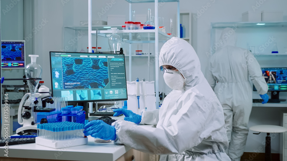 Doctor with protection suit working with blood samples in laboratory ...