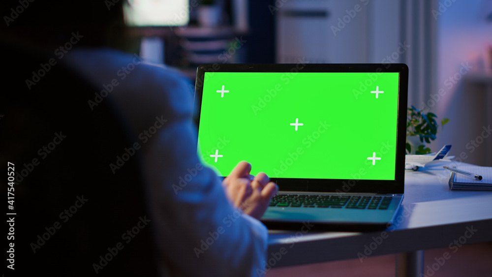 Close up of freelancer typing on laptop with green screen sitting at ...