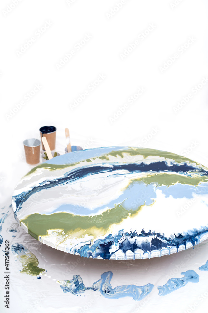 Artistic background. Round canvas with dripping paint. The process of ...