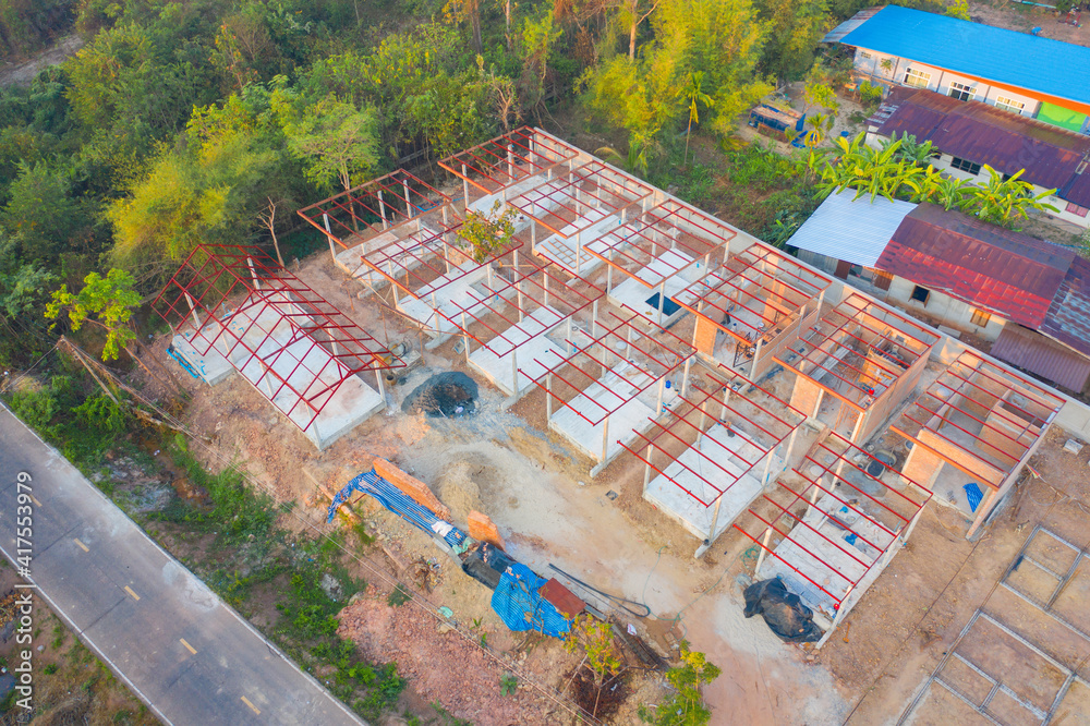 Aerial top view of homes or houses in village under construction site ...