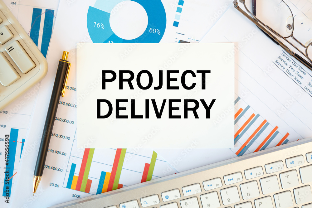 PROJECT DELIVERY is written in a document on the office desk, diagram ...