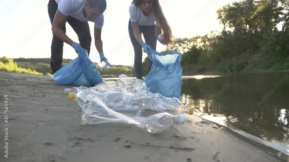 Plastic waste environmental pollution concept. Teamwork of volunteers ...