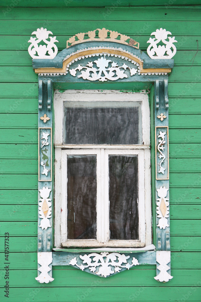 Ornamental window with carved frame on vintage wooden rural house in ...