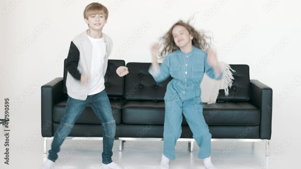 Pretty school children dancing jumping modern dance. Smiling child ...