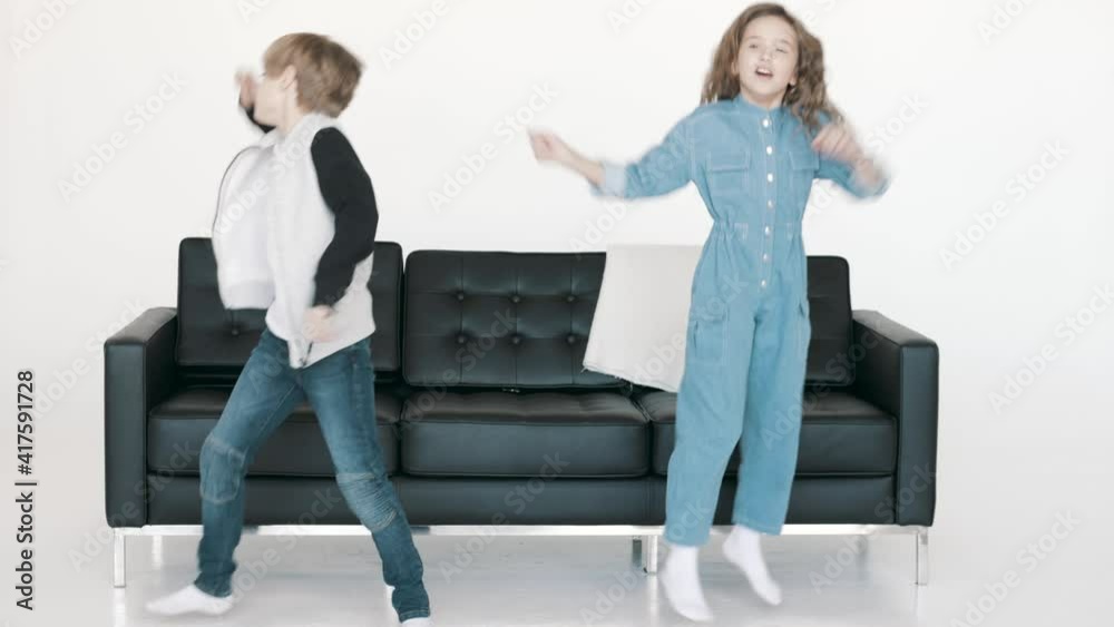 Pretty school children dancing jumping modern dance. Smiling child ...
