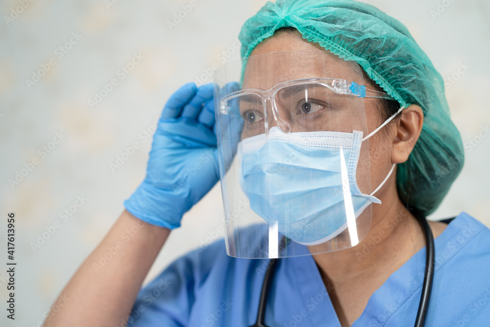 Asian doctor wearing face shield and PPE suit new normal to check ...