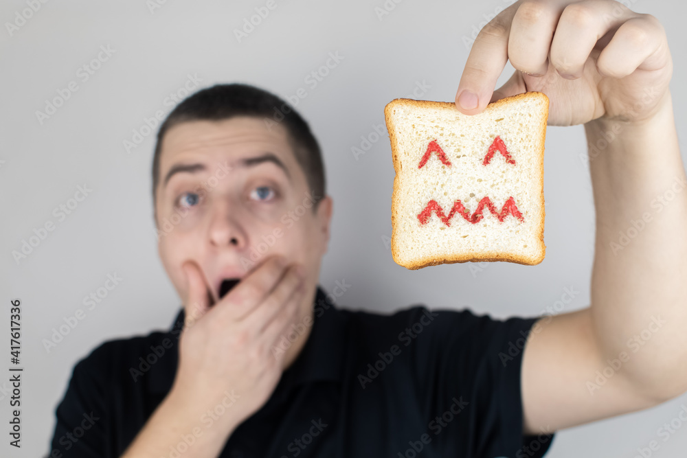 Conceptually about gluten intolerance. The man holds in his hand a ...