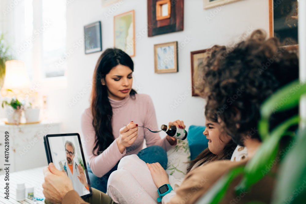 Caring parents communicating about daughter's medical condition with a ...