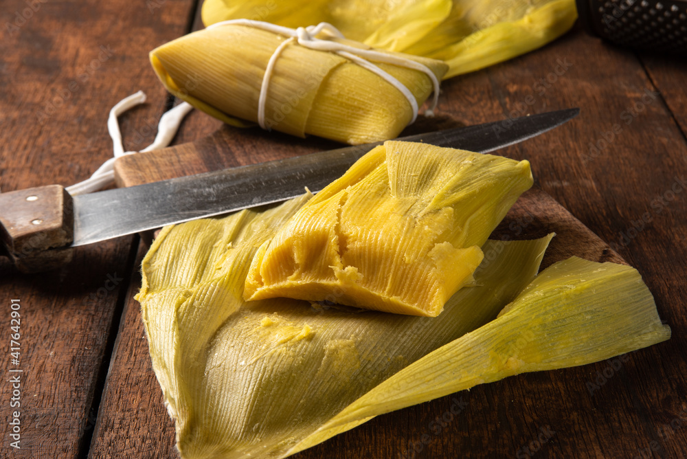 Pamonha, Brazilian corn food, called pamonha. On a rustic table with ...
