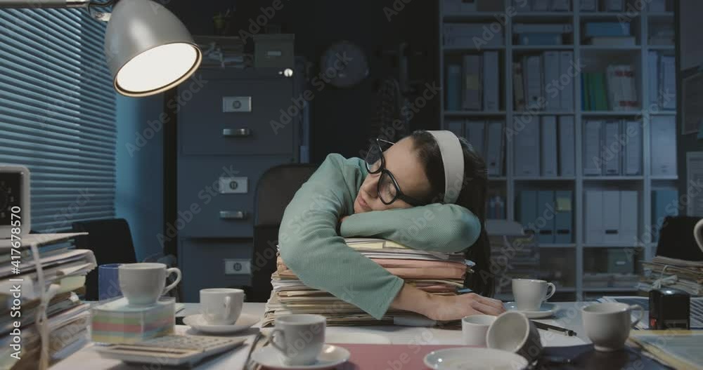 Employee sleeping at desk on a pile of paperwork Stock Video | Adobe Stock