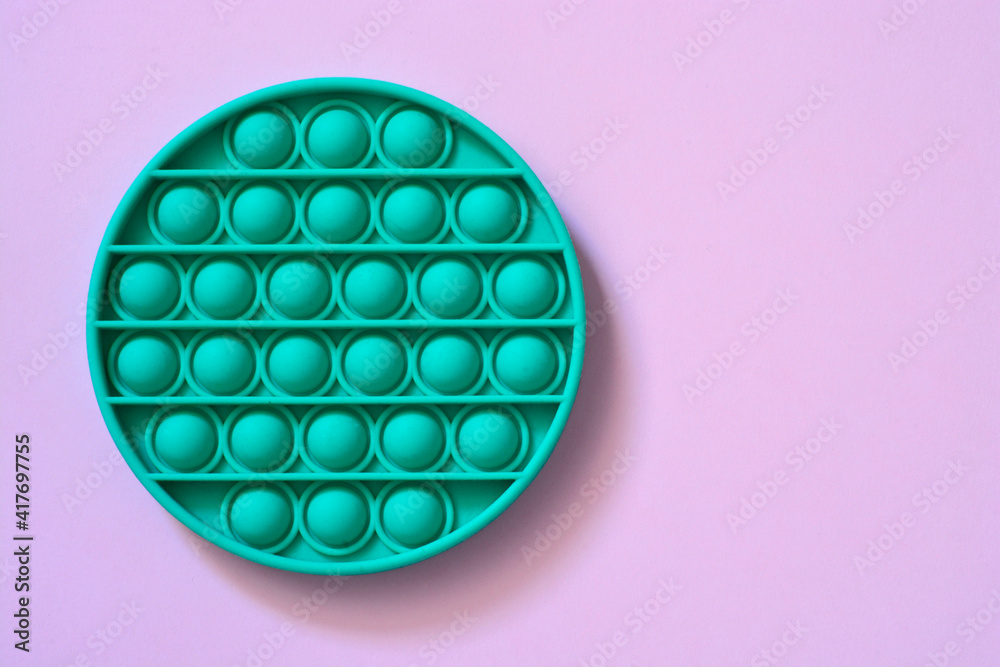 Green pop it fidget toy on a empty copy space background Stock Photo ...
