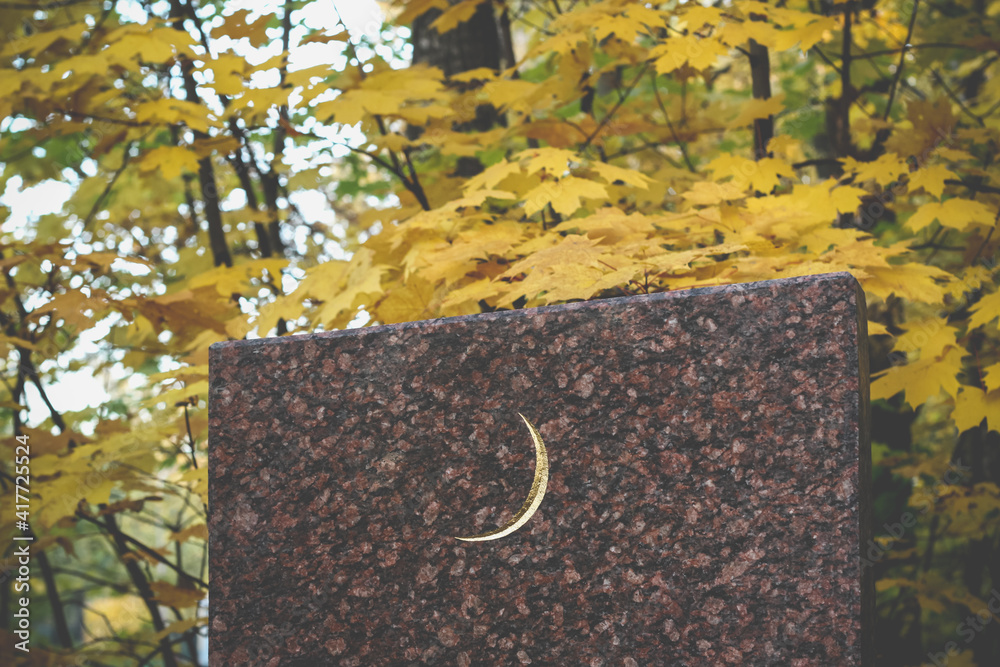White crescent moon symbol on the grave rectangular granite slab ...