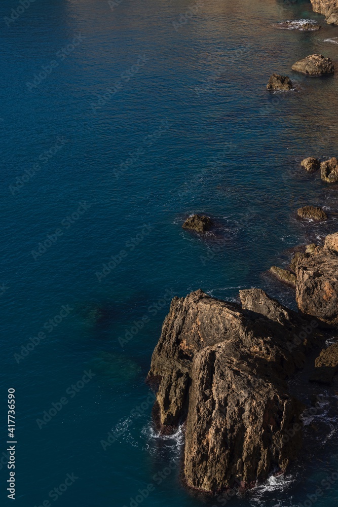 angry waves and waterfalls in the blue sea water ocean coast rocks ...
