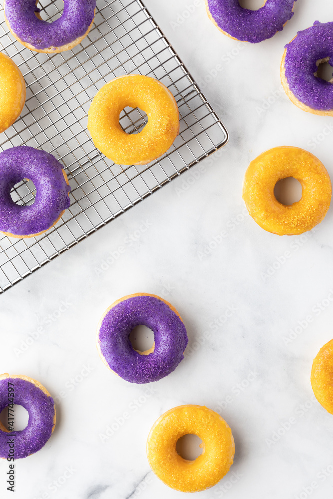 Top down view of donuts on a white marble background with some donuts ...