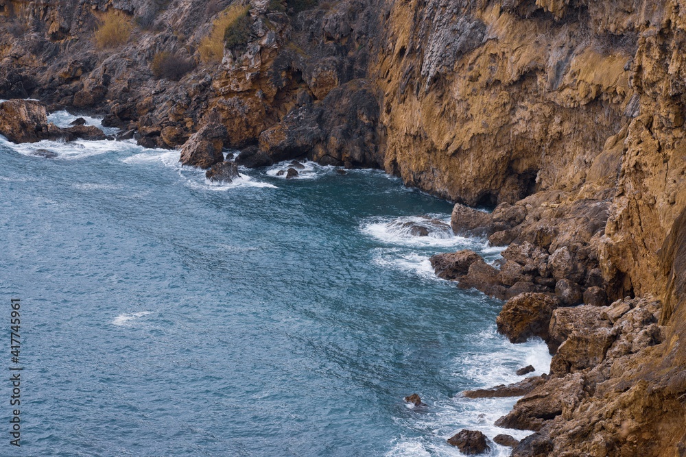 angry waves and waterfalls in the blue sea water ocean coast rocks ...