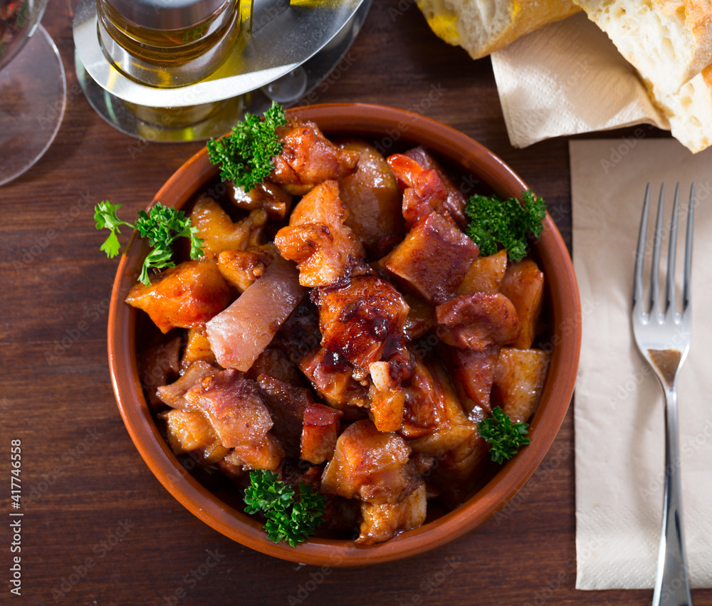 Morro de cerdo - spanish dish. Roast nose and cheek pigs with parsley ...