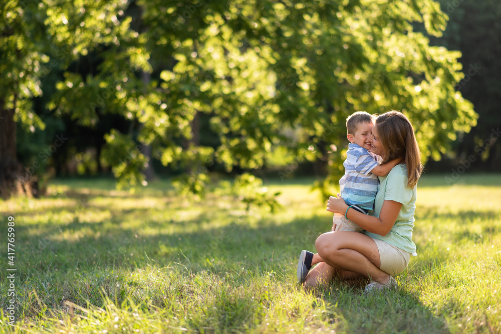 Cute child hugging his mother with love Stock Photo | Adobe Stock