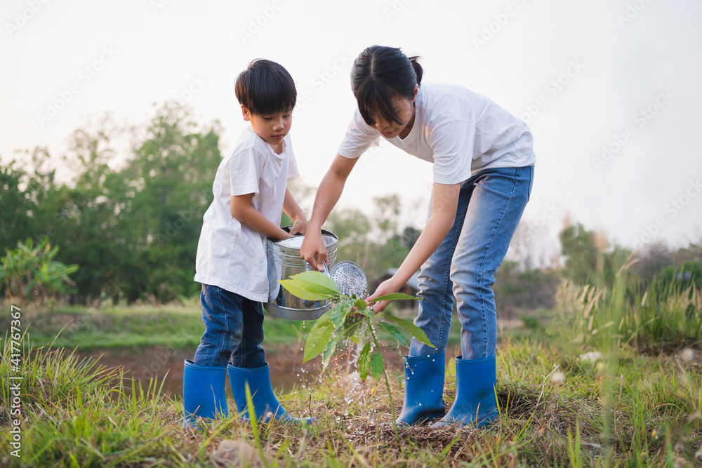 children helping planting tree in garden for save world. eco ...