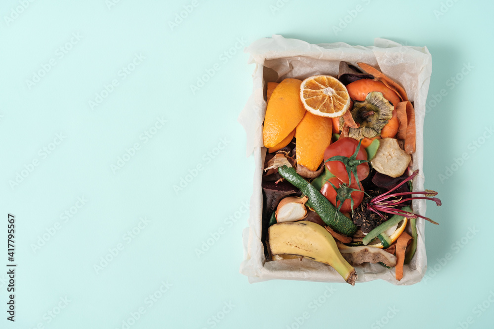 top view food leftovers in compost bin on blue background, compost ...