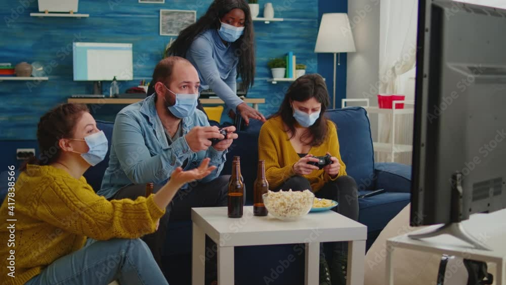 Video Stock Concentrated multiracial friends playing video games with ...