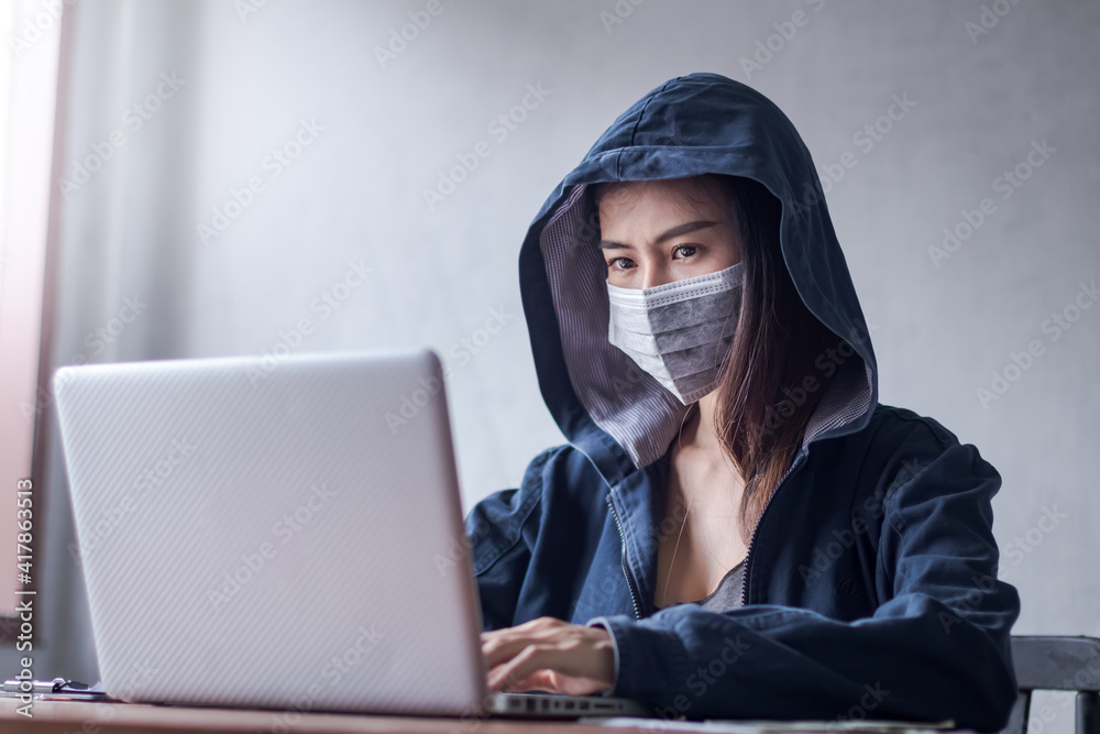 Professional hacker young women Wearing a blue robe with a hood ...