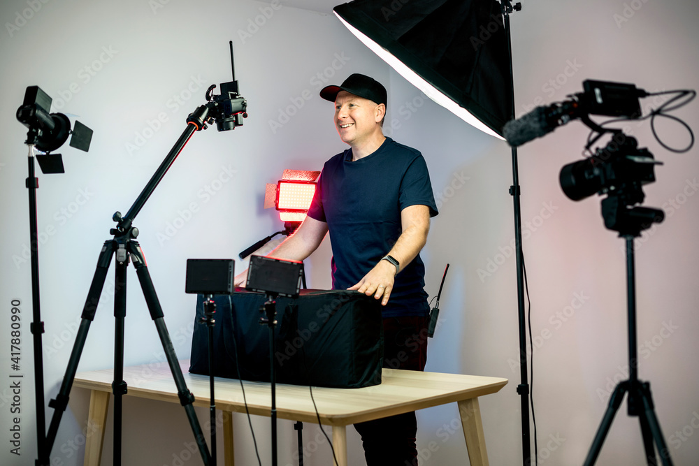 A content creator unboxing in front of his cameras in his studio Stock ...