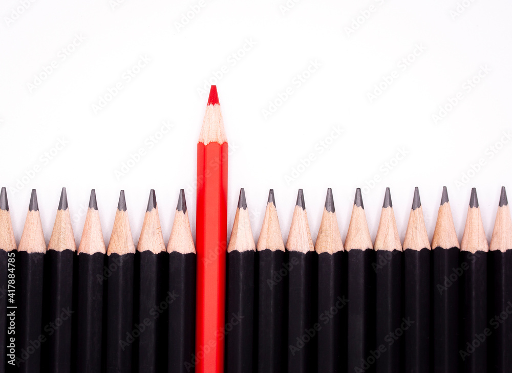 Red pencil in the middle role of black pencil out from crowd of plenty ...