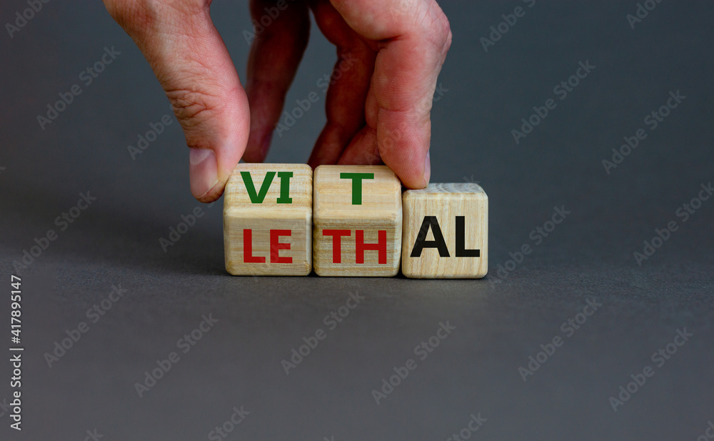 Vital vs lethal symbol. Businessman turns wooden cubes and changes the ...