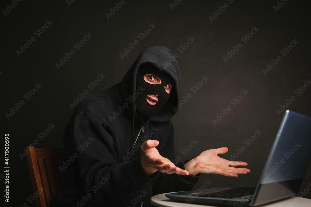 A dangerous masked hacker with a hood cannot infiltrate the data ...